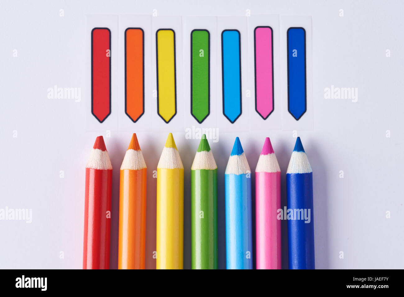 Colored pencils in a row against white background Stock Photo - Alamy
