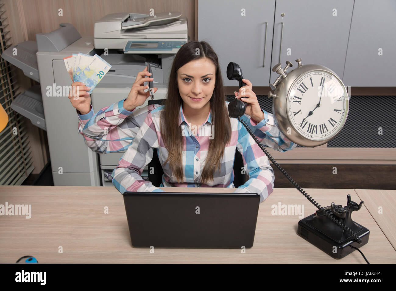 Multitasking business woman is a real miracle at work Stock Photo - Alamy