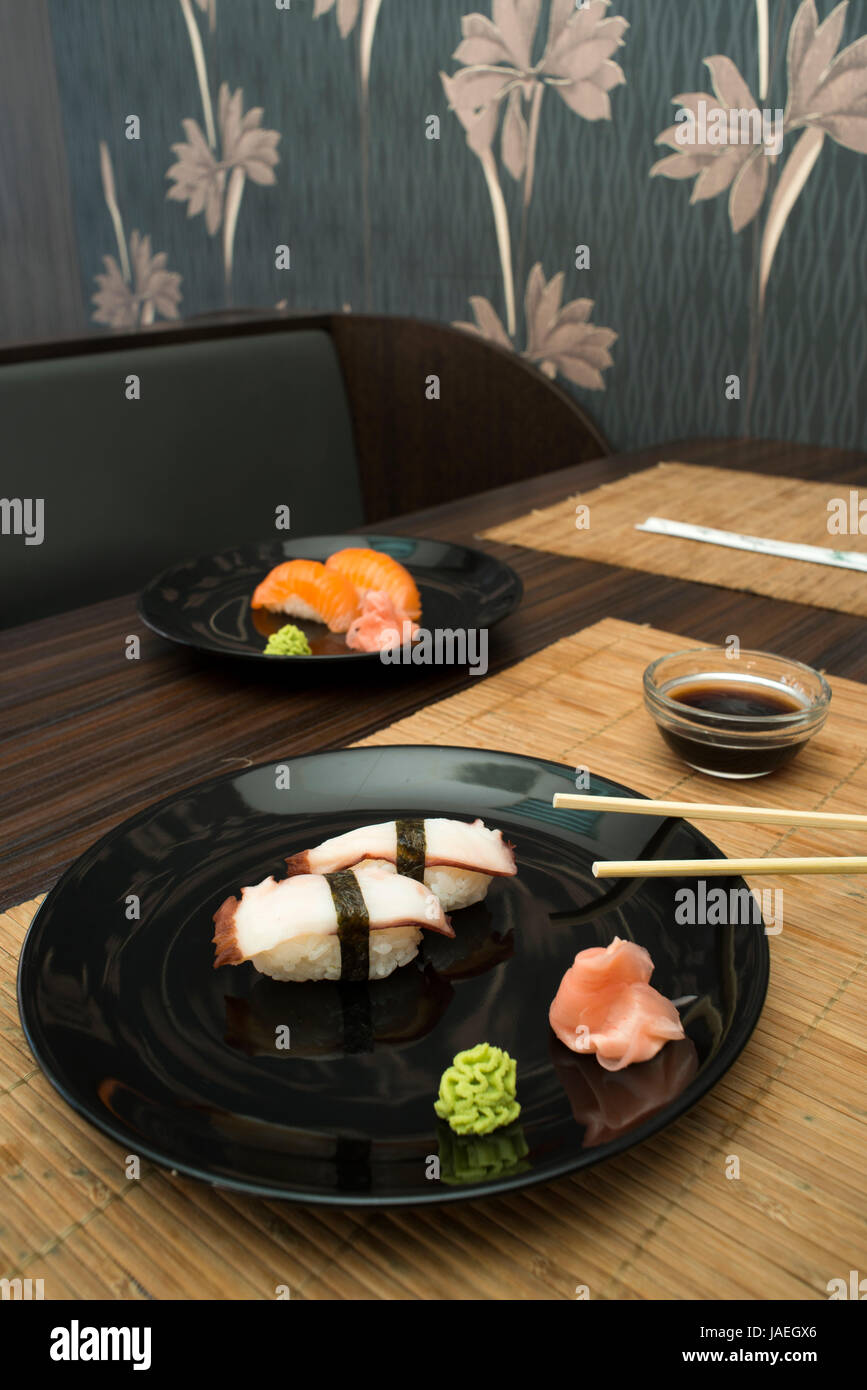Sushi in sushi bar. Table and ration sushi Stock Photo - Alamy