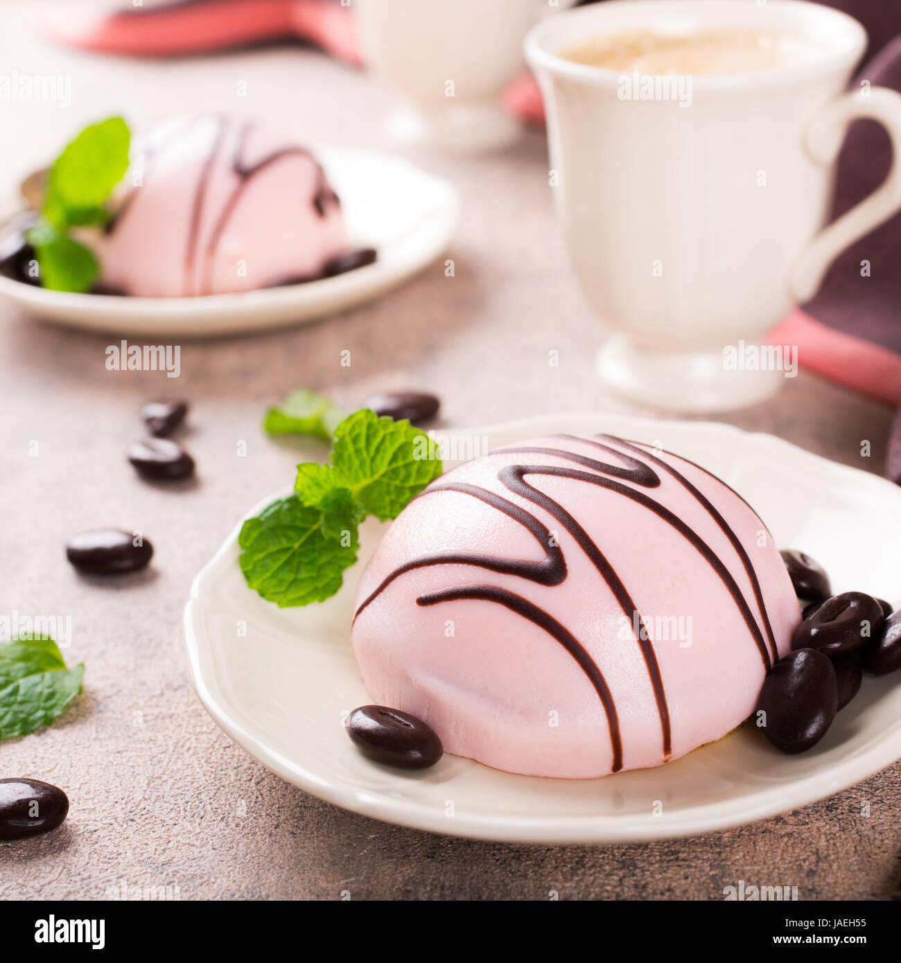 Individual mousse cakes in the form of hemisphere covered with pink ...