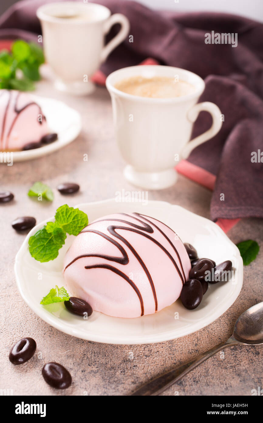 Individual mousse cakes in the form of hemisphere covered with pink ...