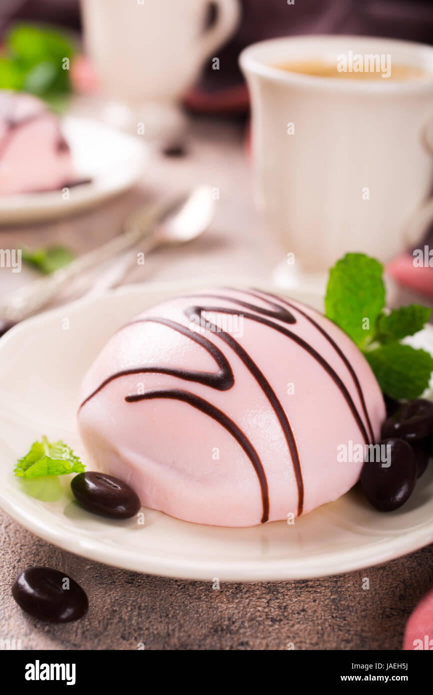 Individual mousse cakes in the form of hemisphere covered with pink ...