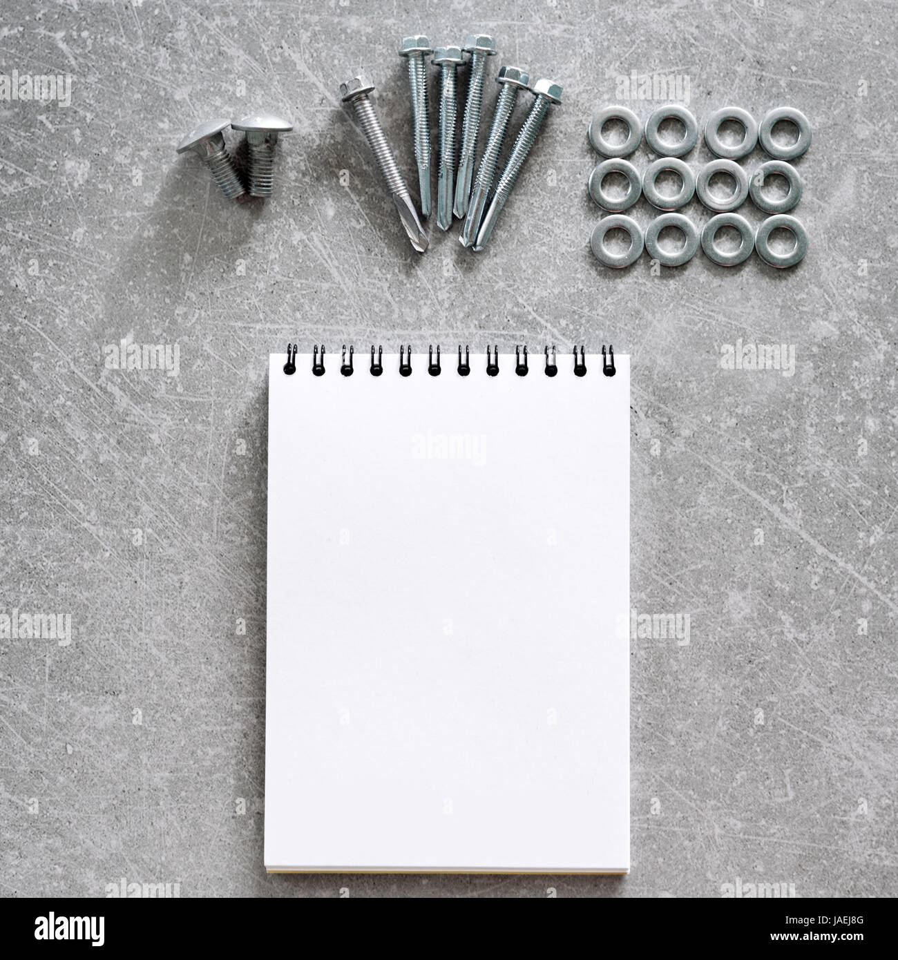 Construction tools. The screws, nuts and bolts arranged around blank ...