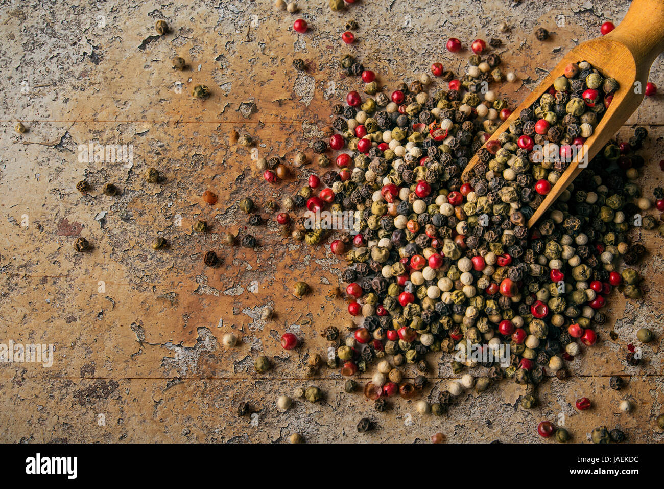Multi-colored peppercorns in a wooden bucket on a old plank Stock Photo ...