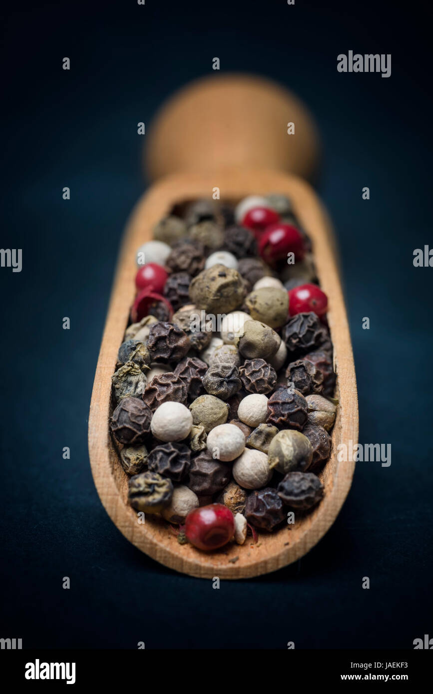 Multi-colored peppercorns in a wooden bucket on a old plank Stock Photo ...