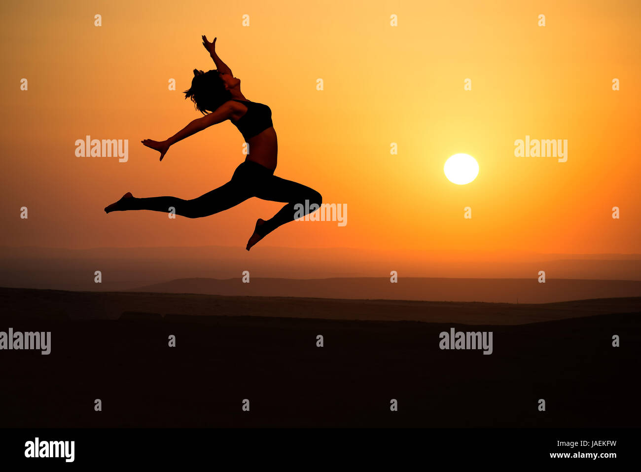 The beauty of a woman dancing in the sunrise.Mountain landscape Stock ...