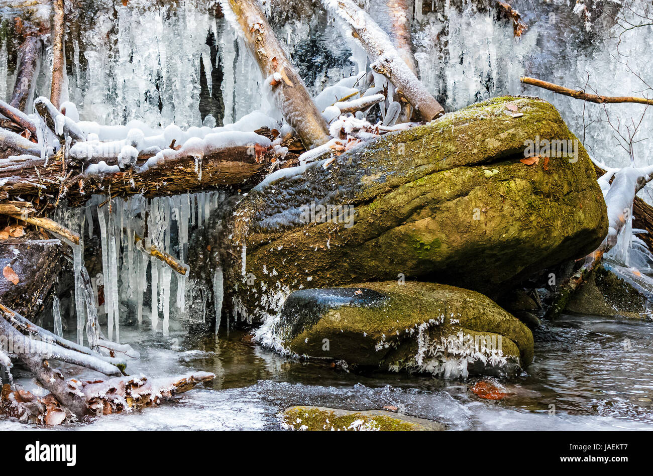 huge boulder in frozen waterfall Stock Photo - Alamy