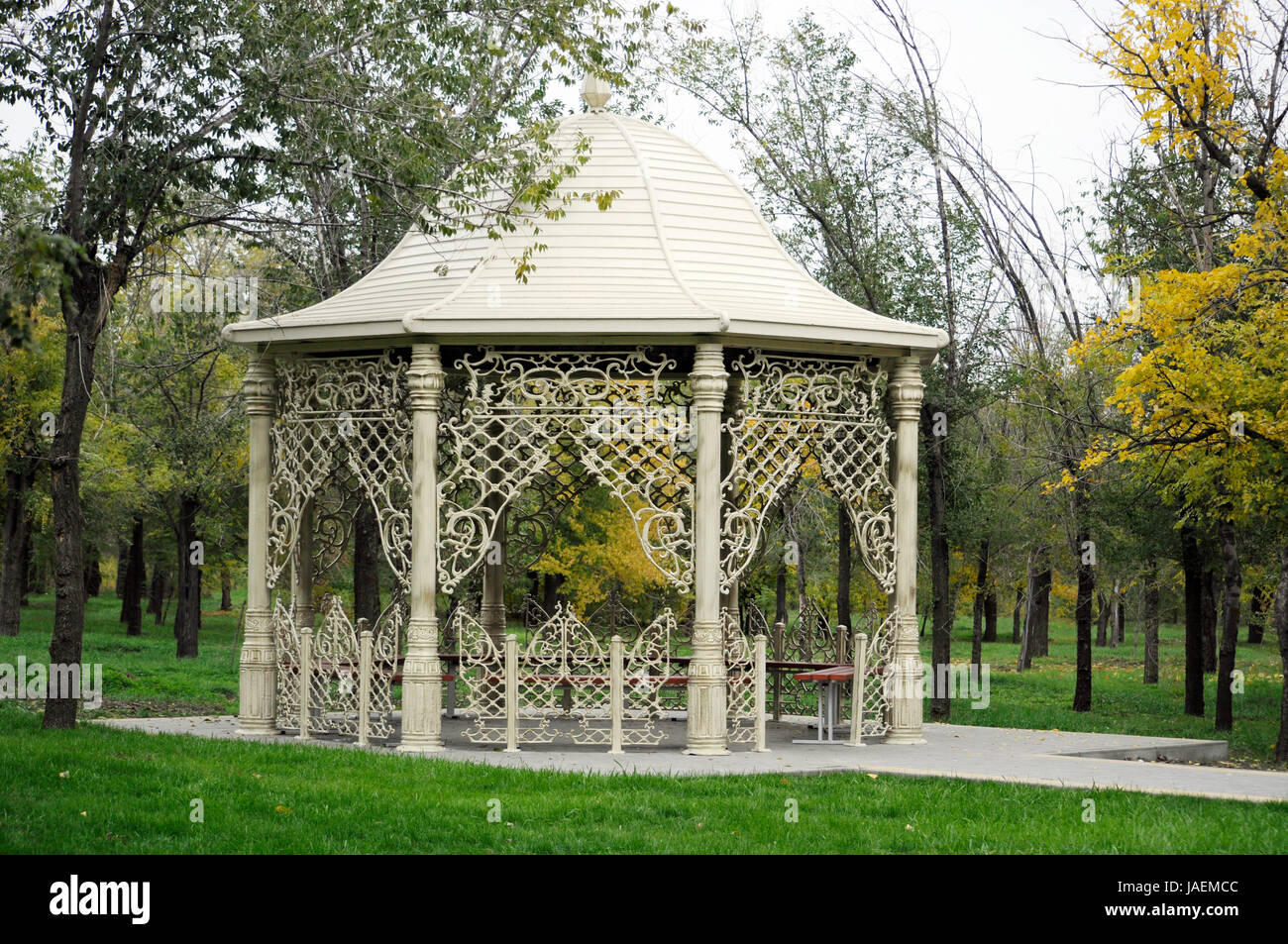 Beautiful arbor in autumn park surrounded by green grass Stock Photo ...