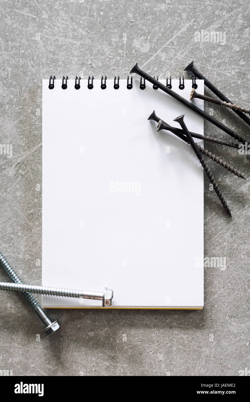 Construction tools. The screws and bolts arranged around blank spiral ...