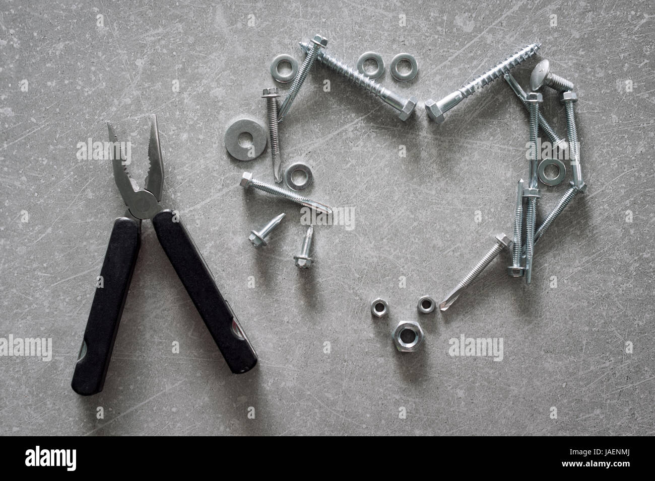 Heart symbol made of screws, nuts and bolts. Heart-shaped construction ...