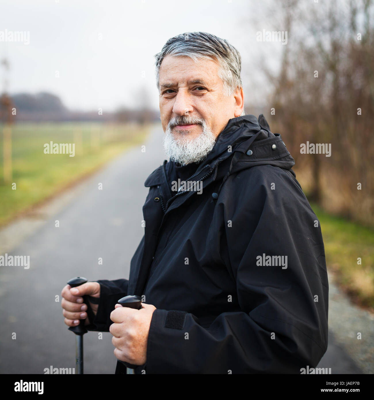 Senior man nordic walking, enjoying the outdoors, the fresh air ...