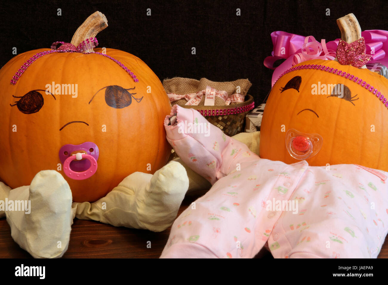 Two pumpkins dressed up as princess babies with pacifiers Stock Photo ...