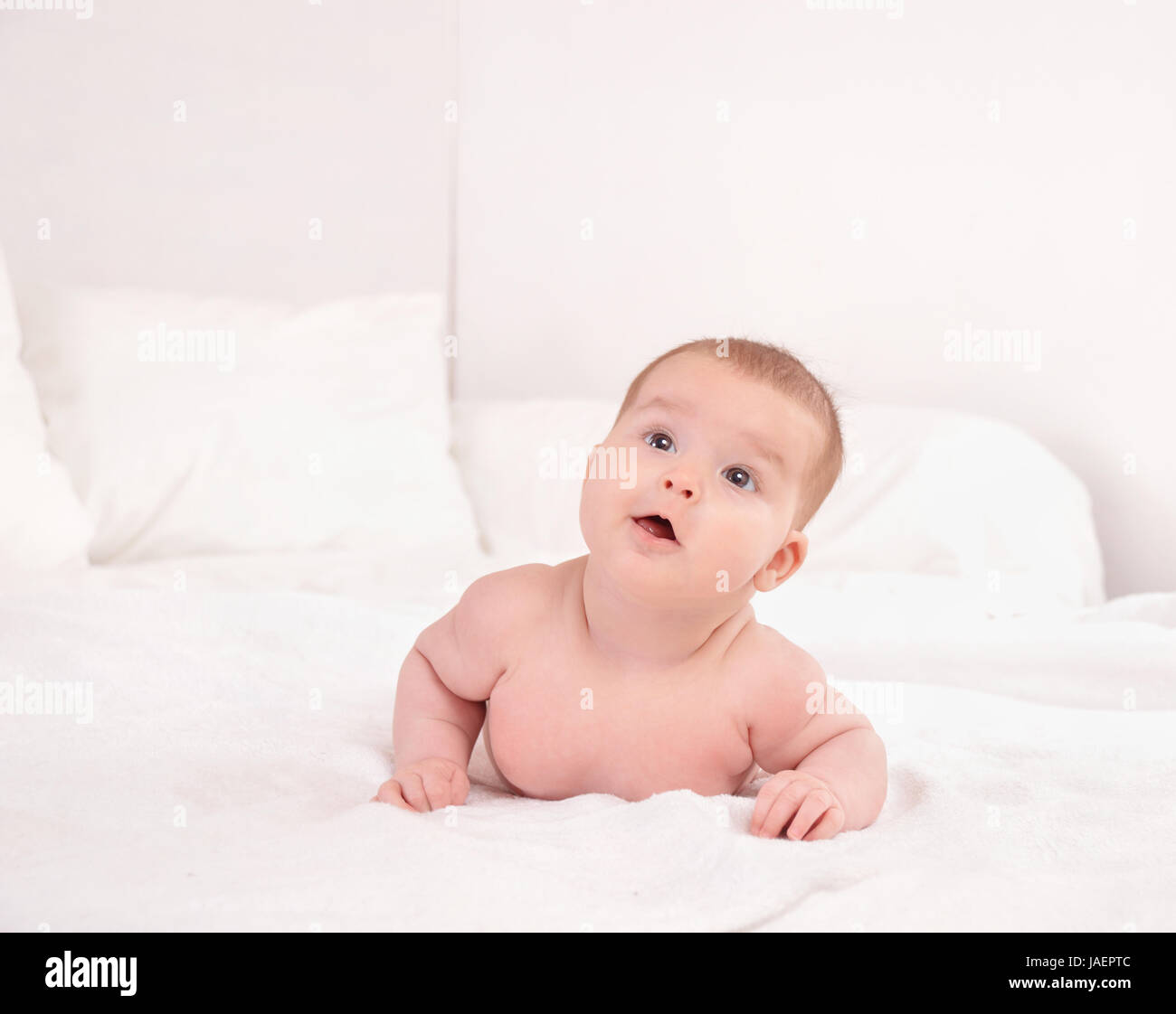 Happy newborn girl lying on her back and smile. Happy motherhood ...