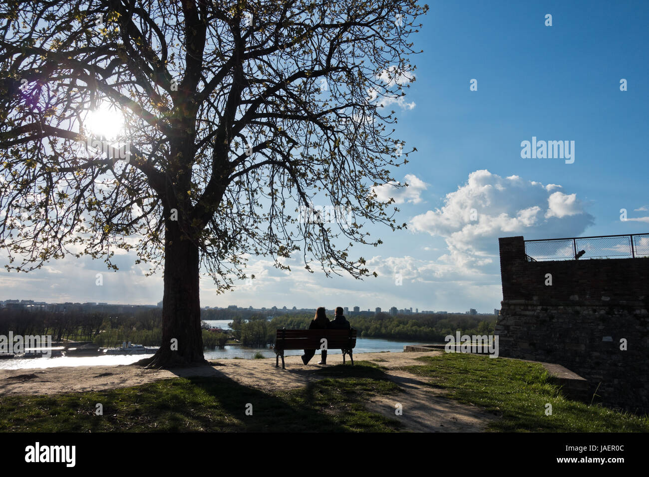 Young couple is sitting on a bench at Kalemegdan fortress in Belgrade ...