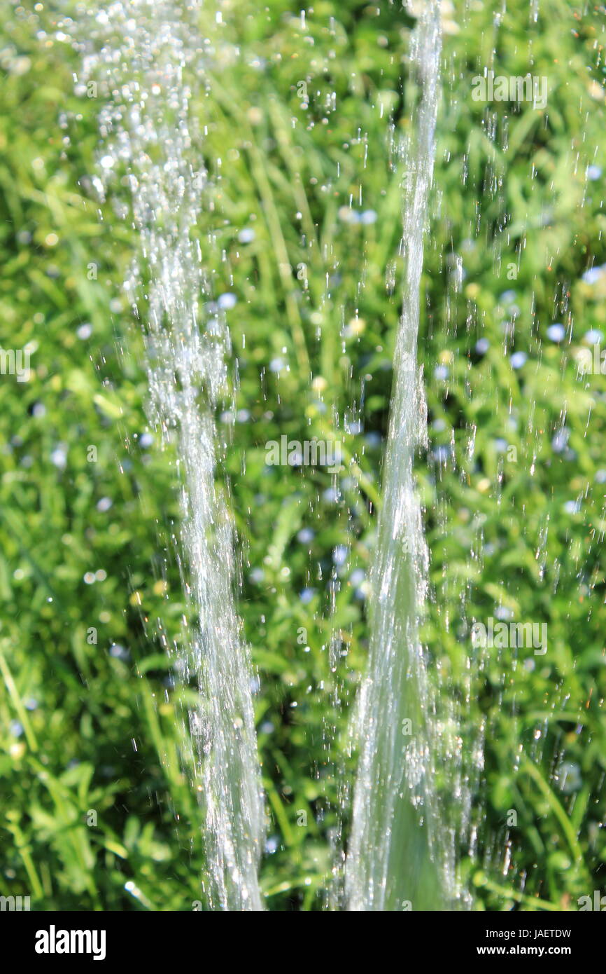 image with jet of falling water on the green background Stock Photo - Alamy