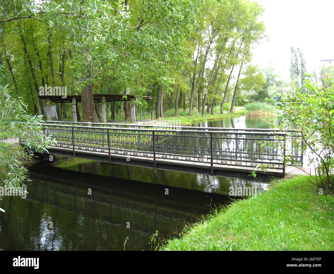 nice bridge across river in the park Stock Photo - Alamy