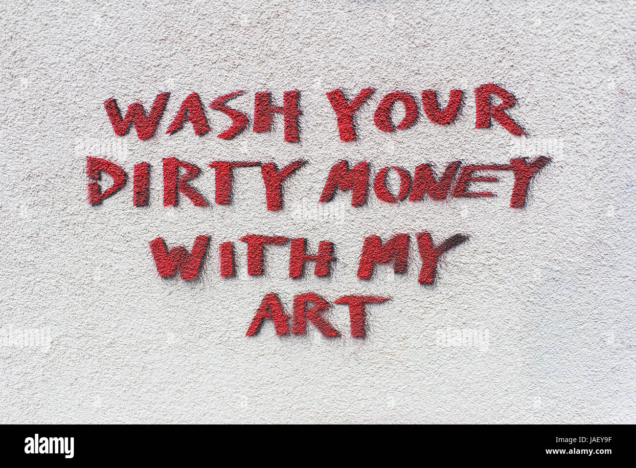 Wall in Prague covered in graffiti and art work, wash your dirty money ...
