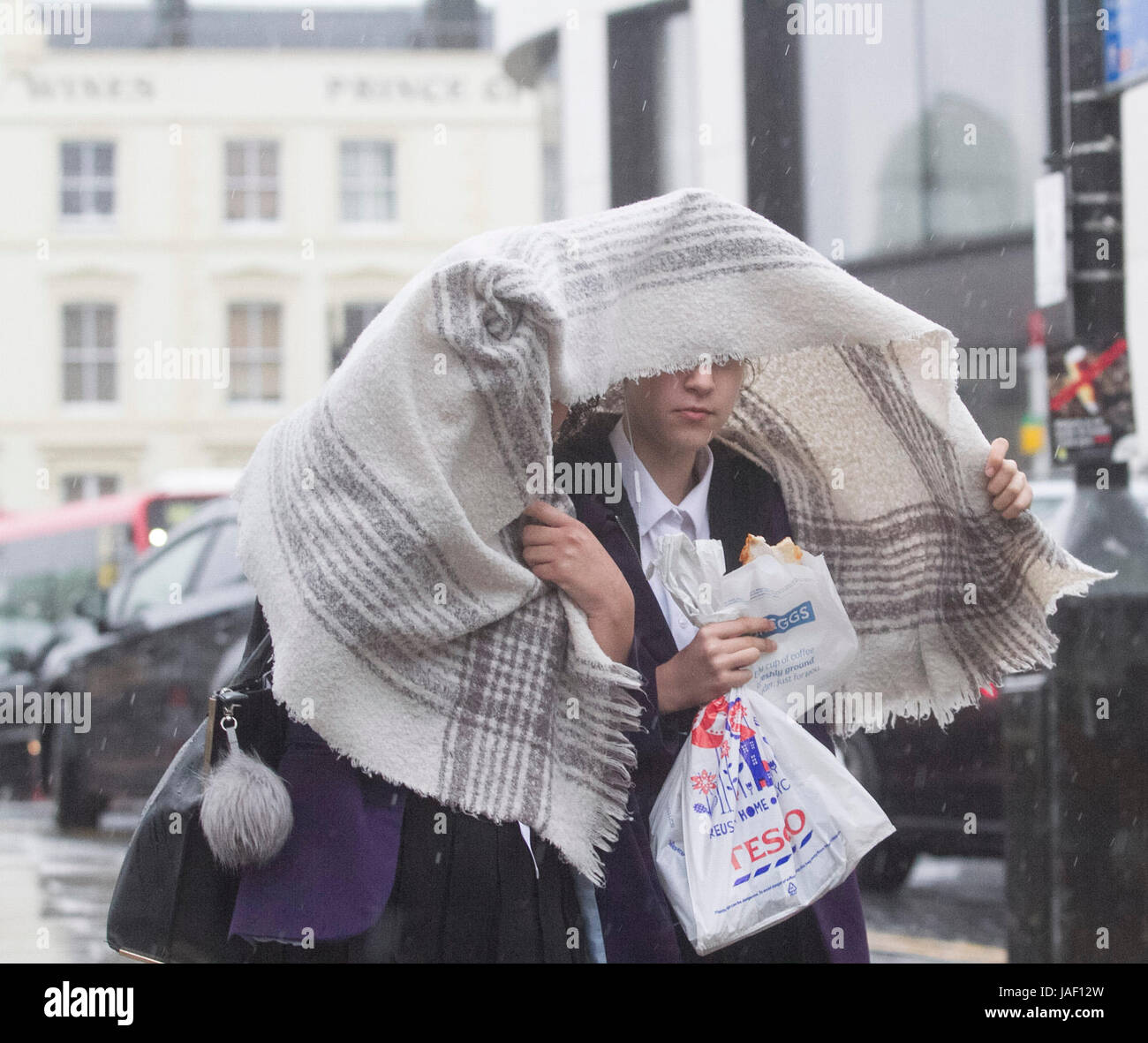 London UK. 6th June 2017. School girls covers their heads with a ...