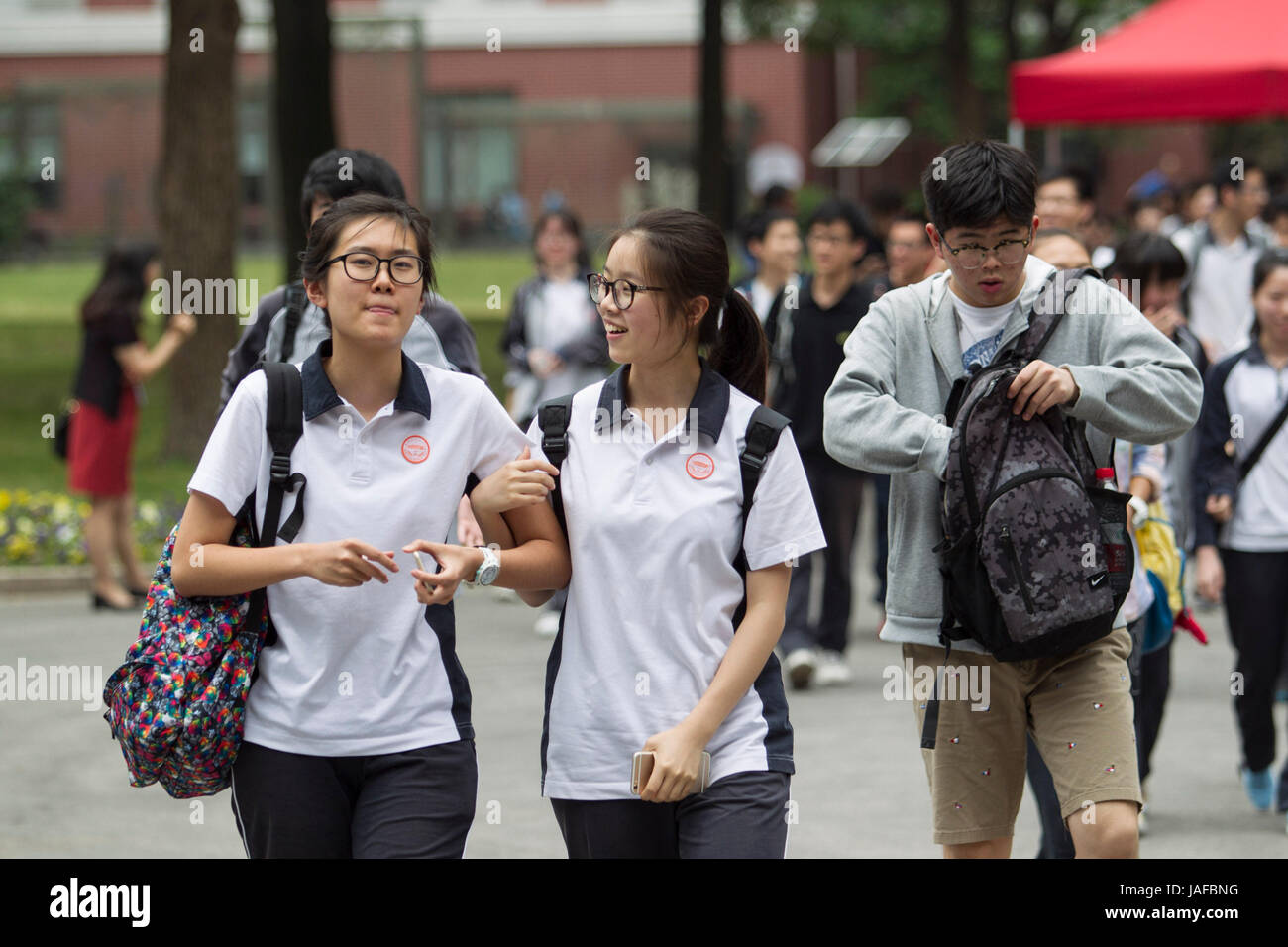 Shanghai, China. 7th June, 2017. Examinees walk out of the exam venue ...