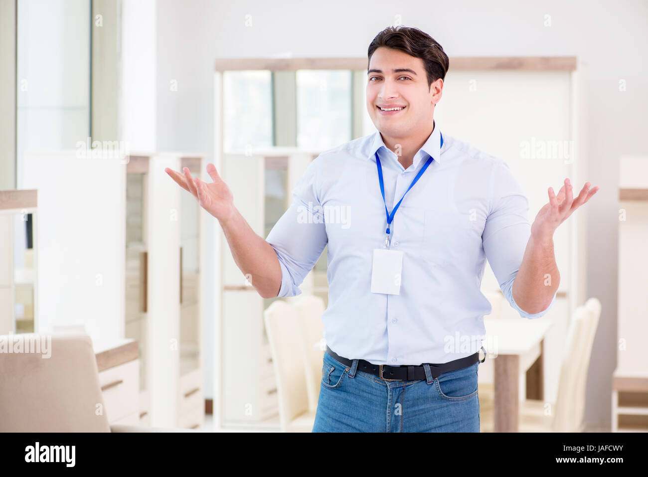 Sales assistant in furniture store Stock Photo - Alamy