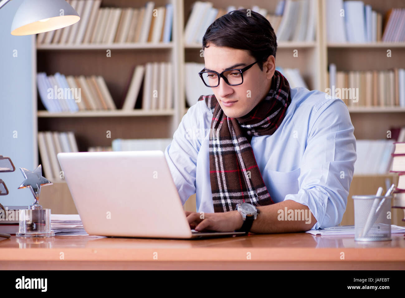 Young writer working in the library Stock Photo - Alamy