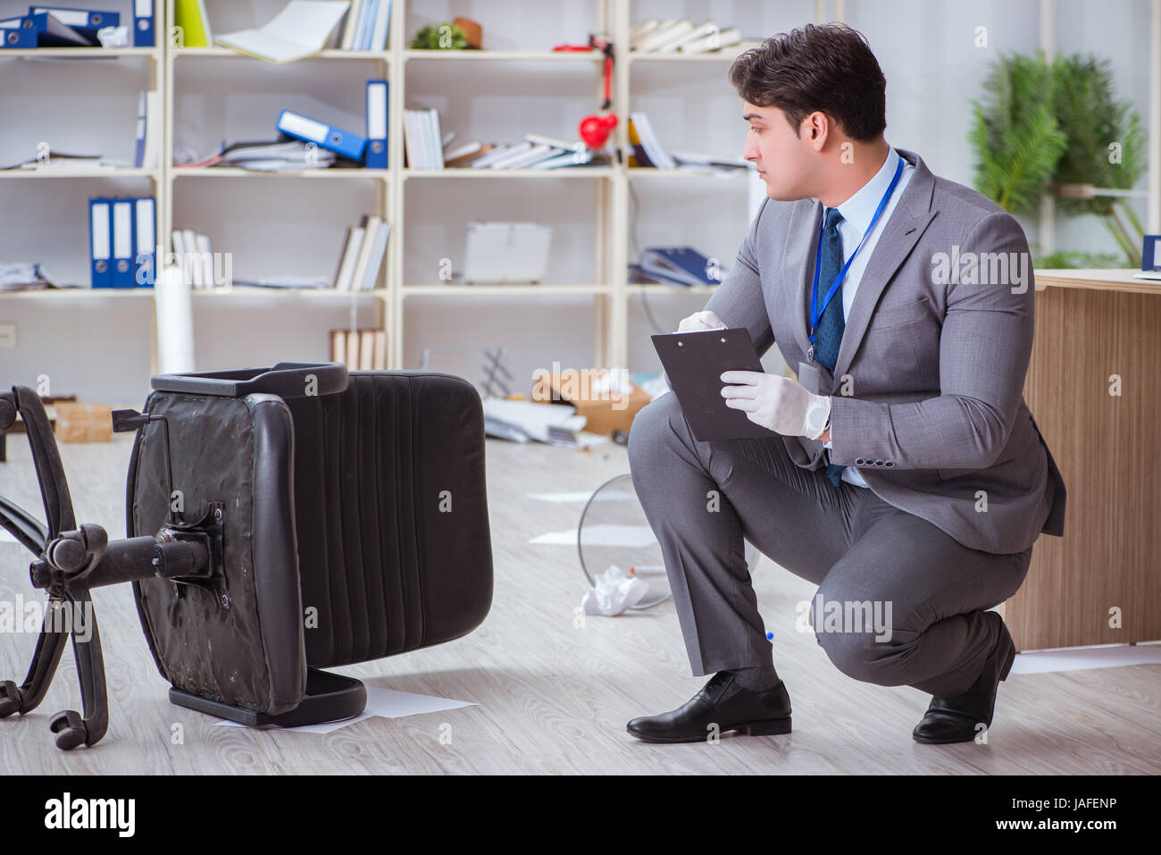 Young man during crime investigation in office Stock Photo - Alamy