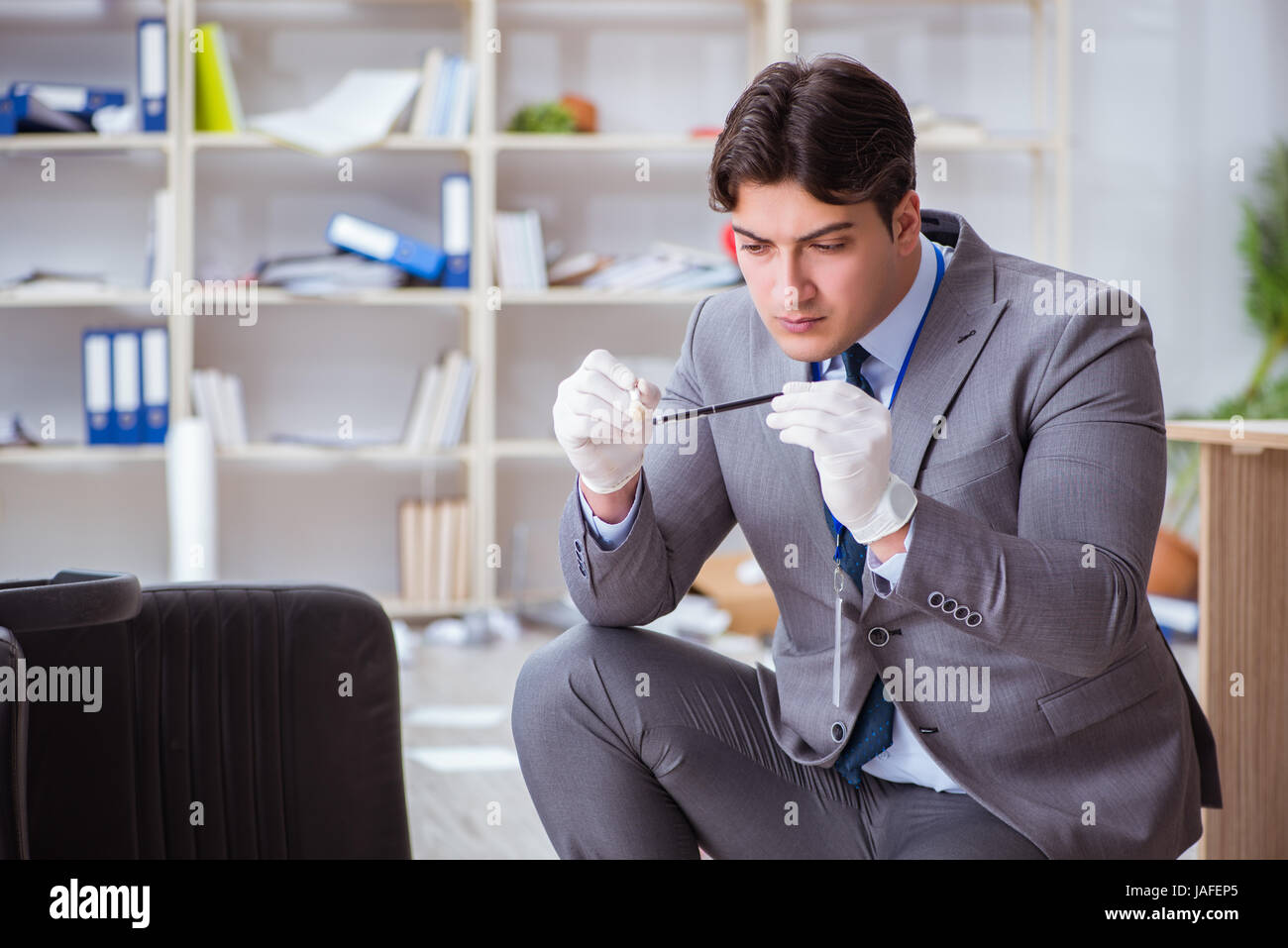 Young man during crime investigation in office Stock Photo - Alamy