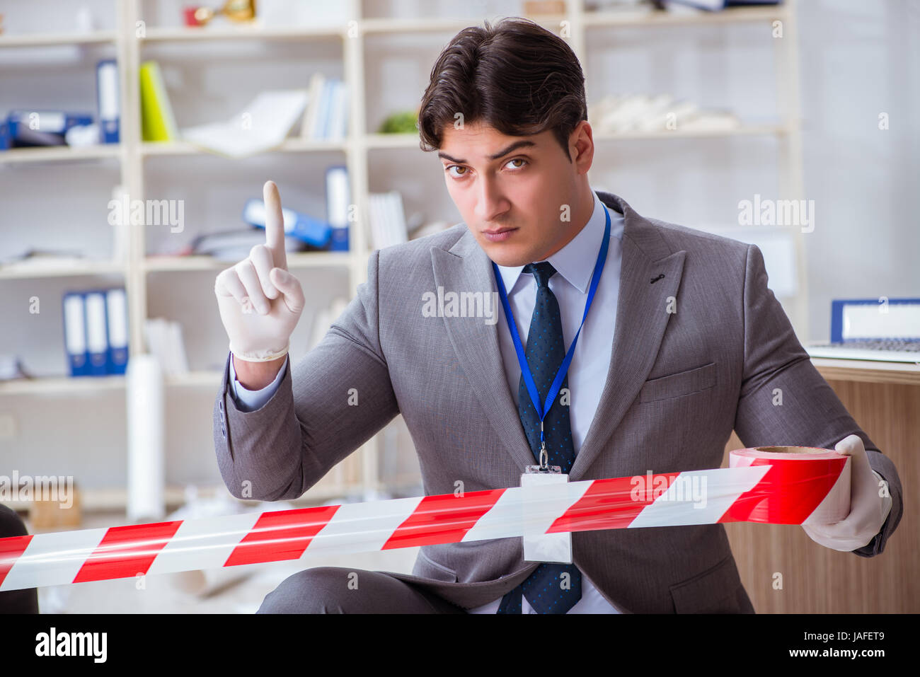 Young man during crime investigation in office Stock Photo - Alamy