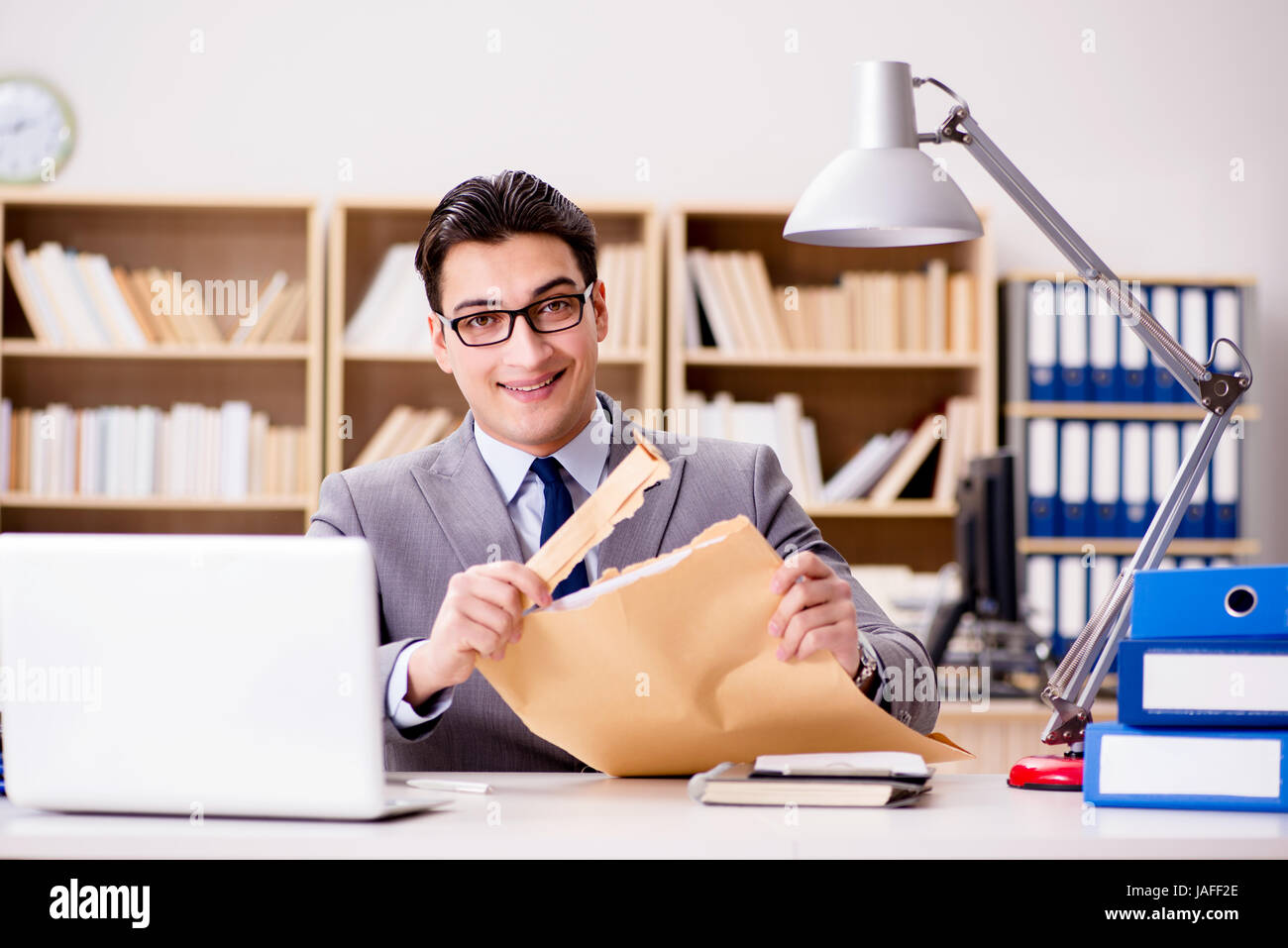 Businessman receiving letter envelope in office Stock Photo - Alamy