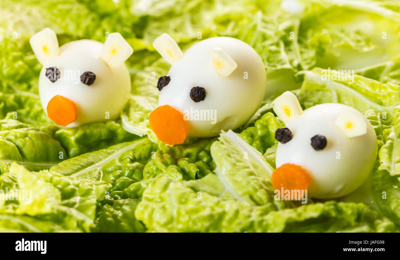 Children food, little pigs of quail eggs with lettuce Stock Photo - Alamy