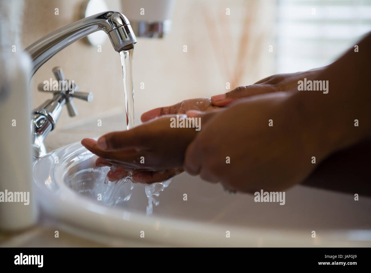 Elderly woman washing hands hi-res stock photography and images - Alamy