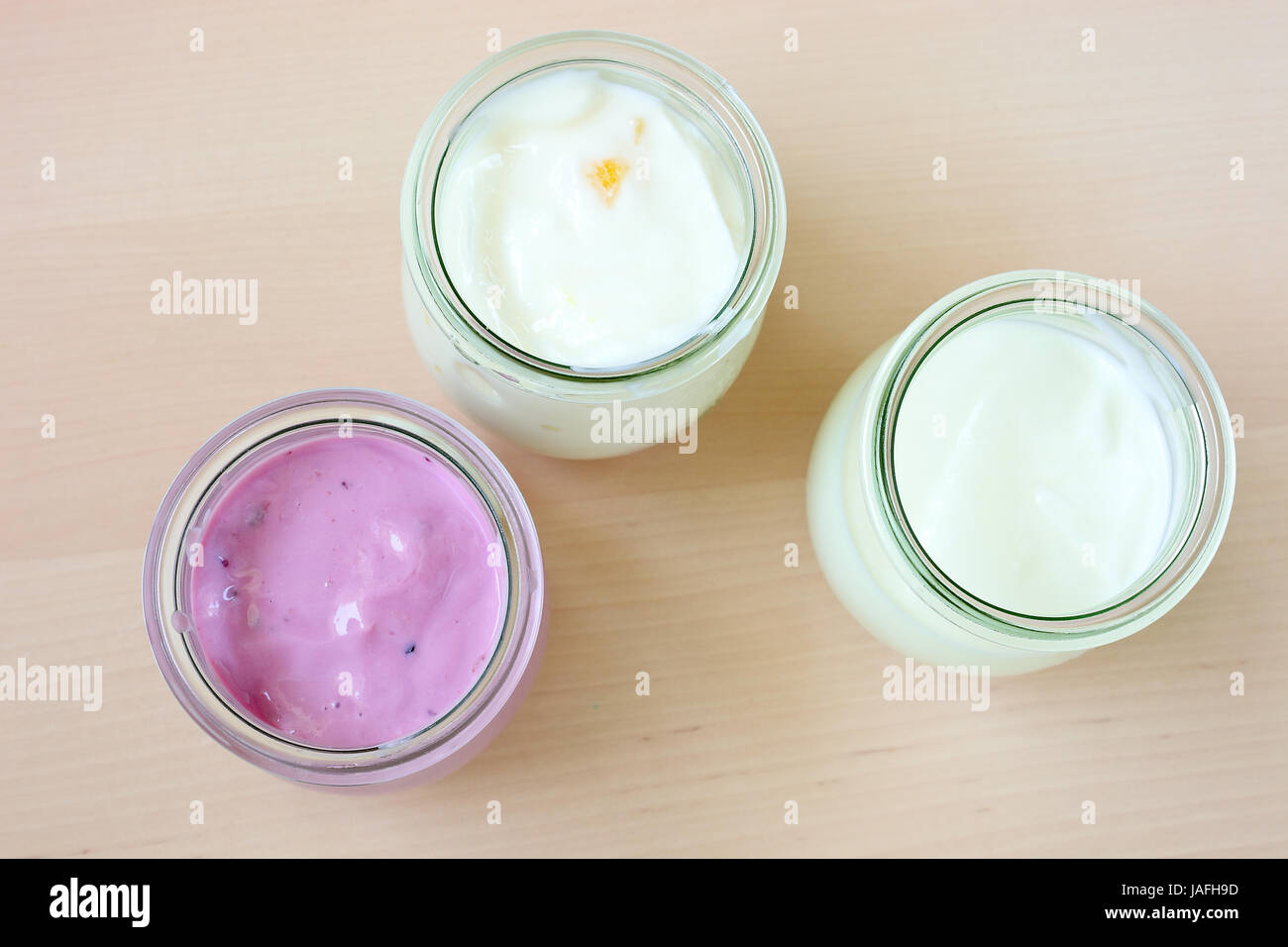 Three glass jars of yogurt Stock Photo - Alamy