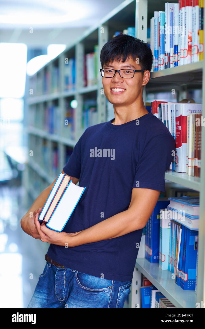 One young male asian or Chinese college students looking at camera ...