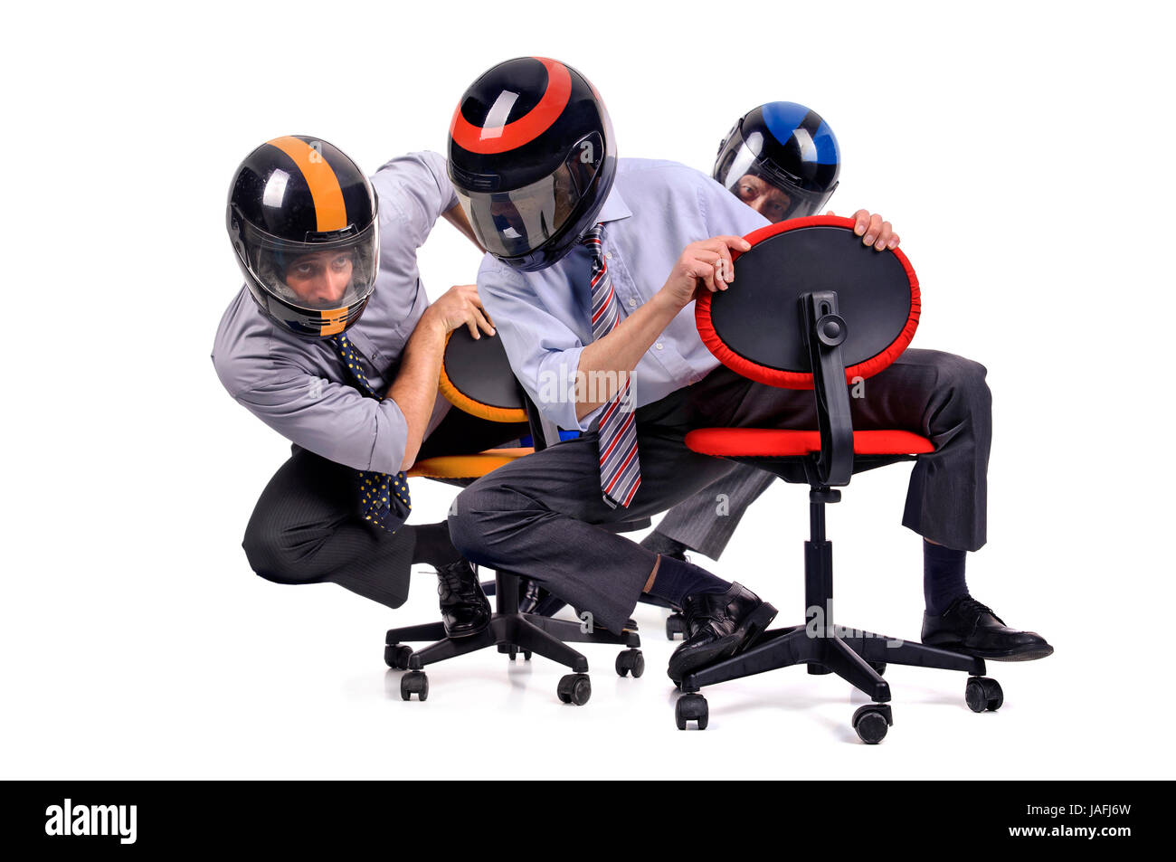 Businessmen racing in chairs with helmets Stock Photo - Alamy