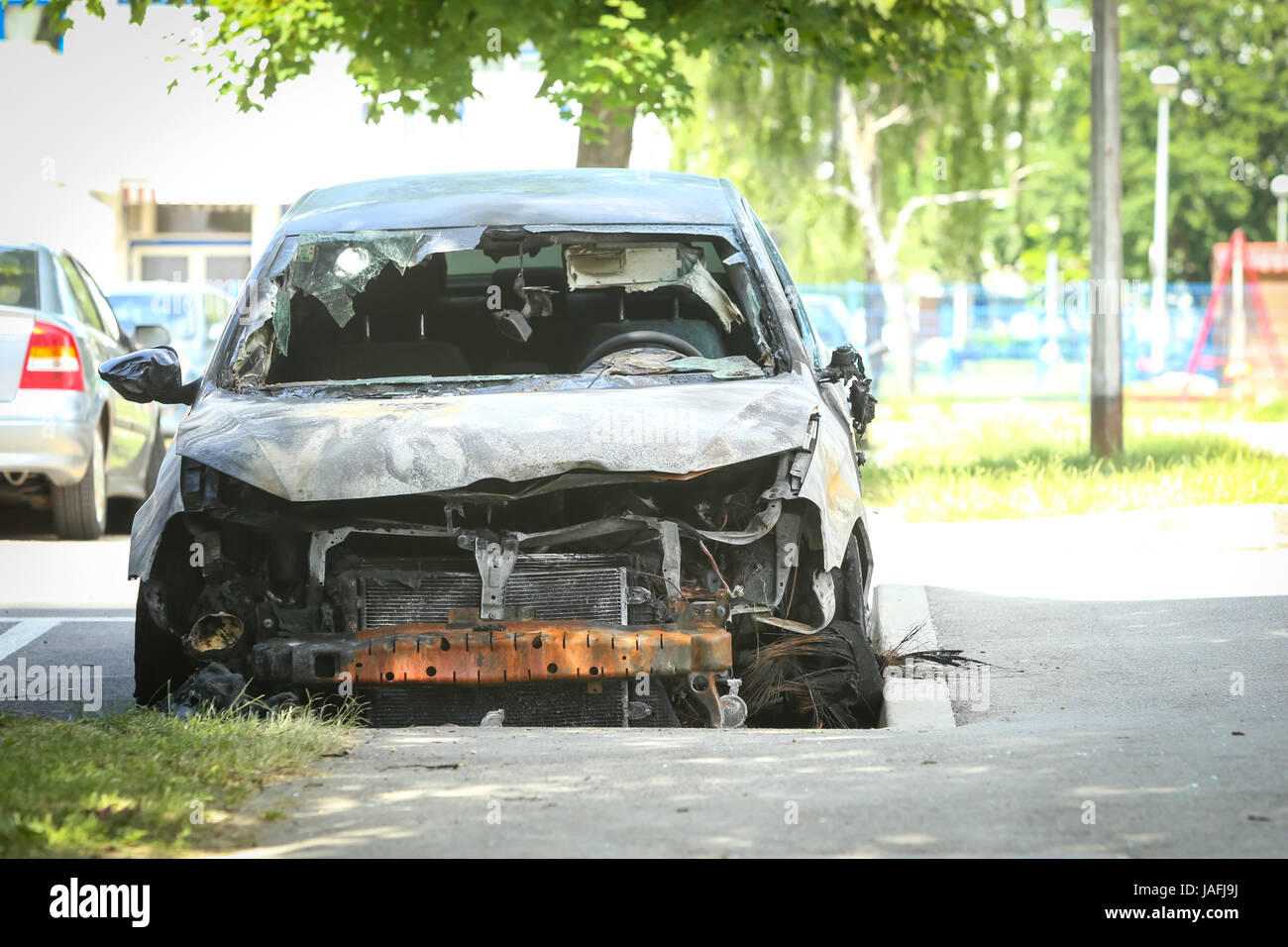 The exterior of a burned out car at a parking lot Stock Photo - Alamy