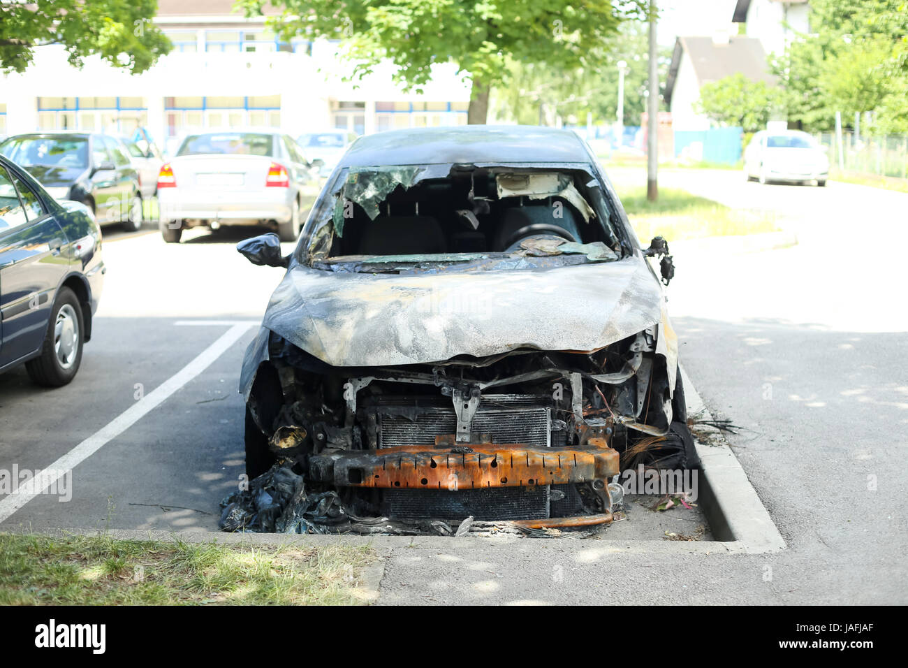 The exterior of a burned out car at a parking lot Stock Photo - Alamy