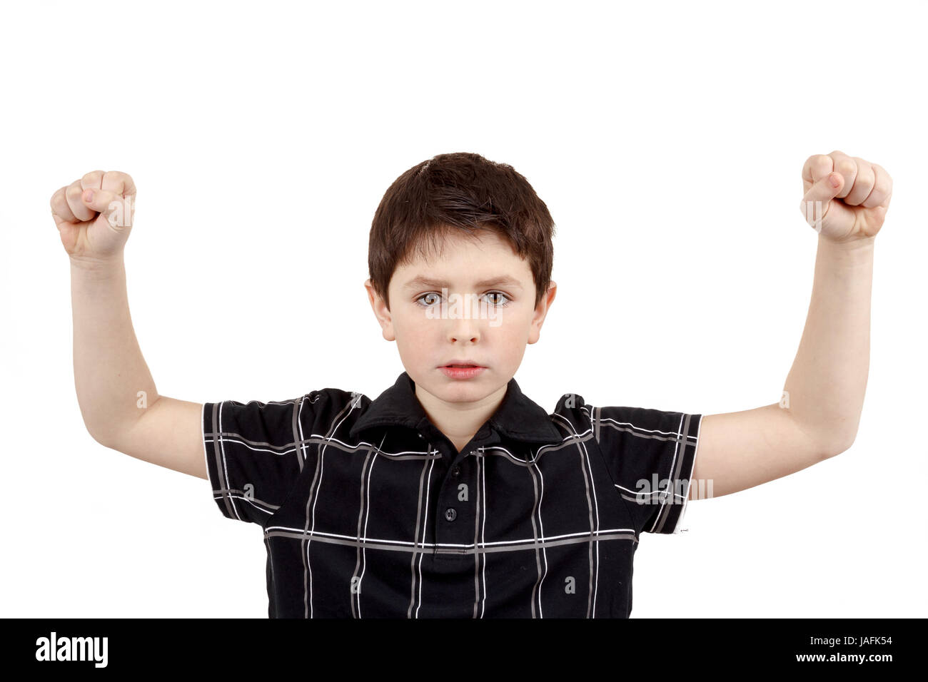 Portrait of a young boy with hand raised up against white background ...