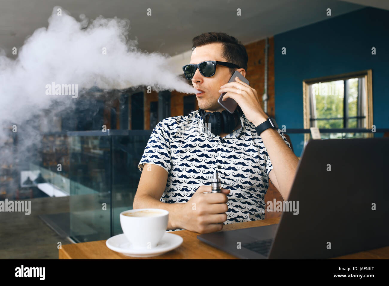 Man vaping in cafe hi-res stock photography and images - Alamy