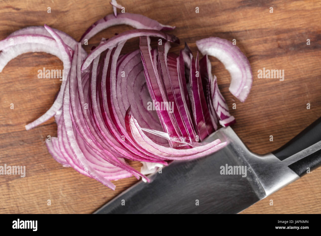the chopped onion half-rings on a wooden background Stock Photo - Alamy