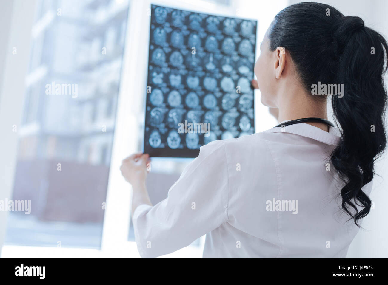 Detecting tumor in organism. Female charming smart oncologist working ...