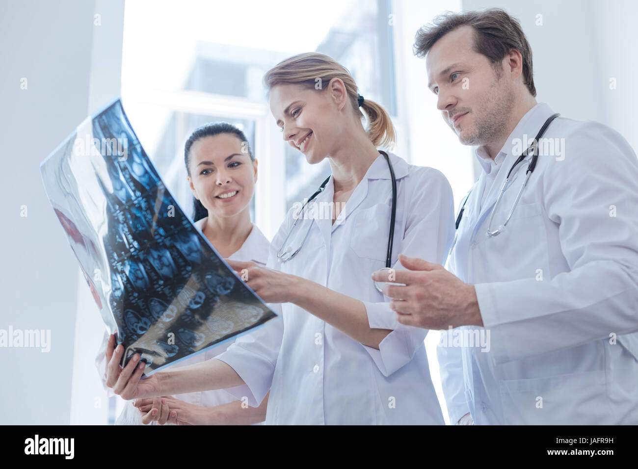 Revealing transmitted x rays through patient body. Experienced cheerful ...