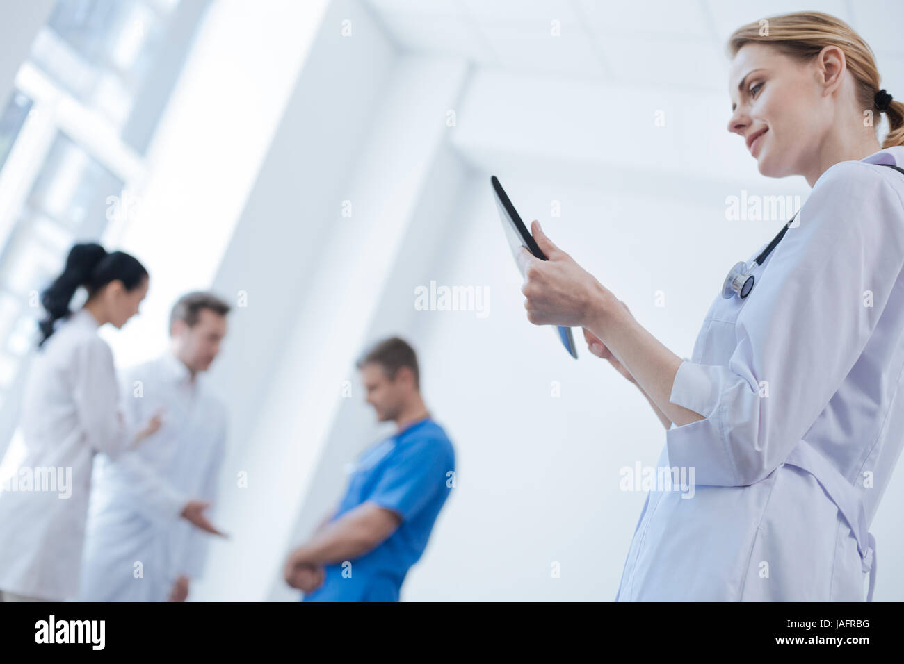 Enjoying free minutes at work. Involved delighted interested doctor ...