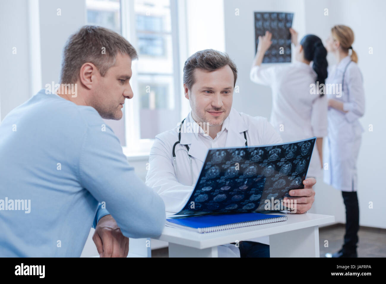Doctor analyzing explaining mri scan hi-res stock photography and ...