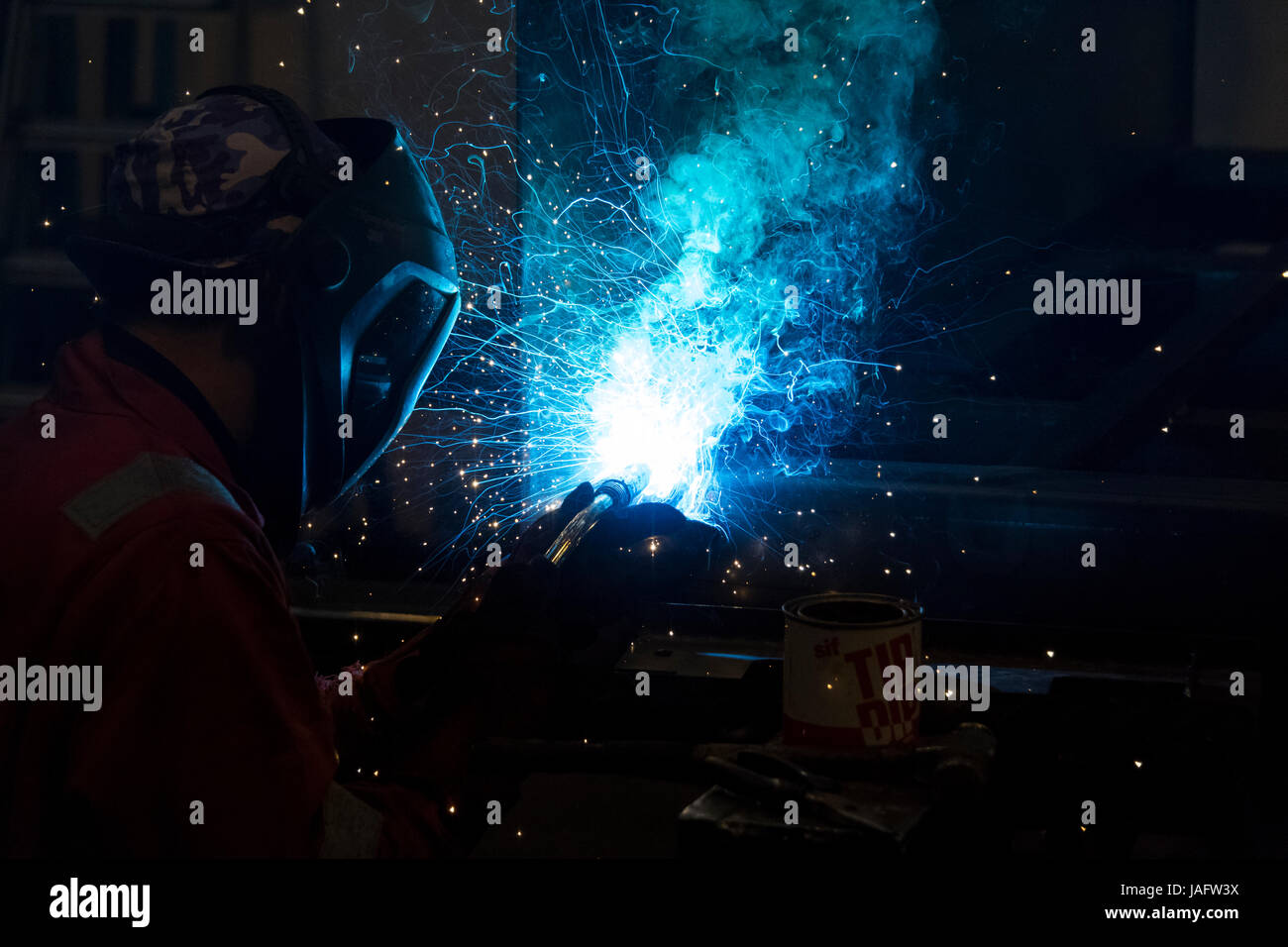 Factory worker welding in a manufacturing plant Stock Photo - Alamy