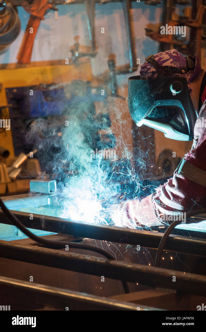 Factory worker welding in a manufacturing plant Stock Photo - Alamy