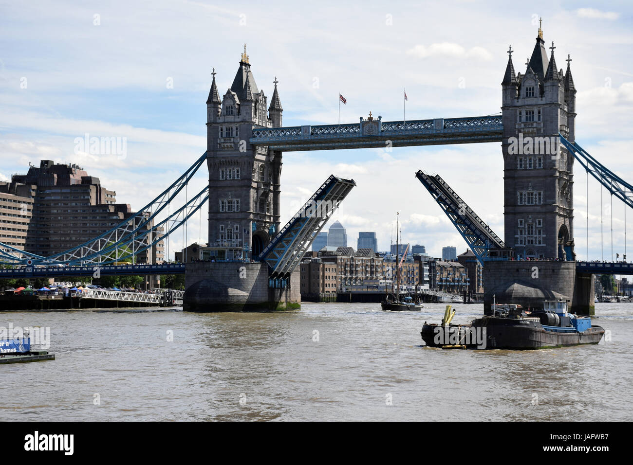 Tower Bridge opening for a yacht, River Thames, London UK Stock Photo ...