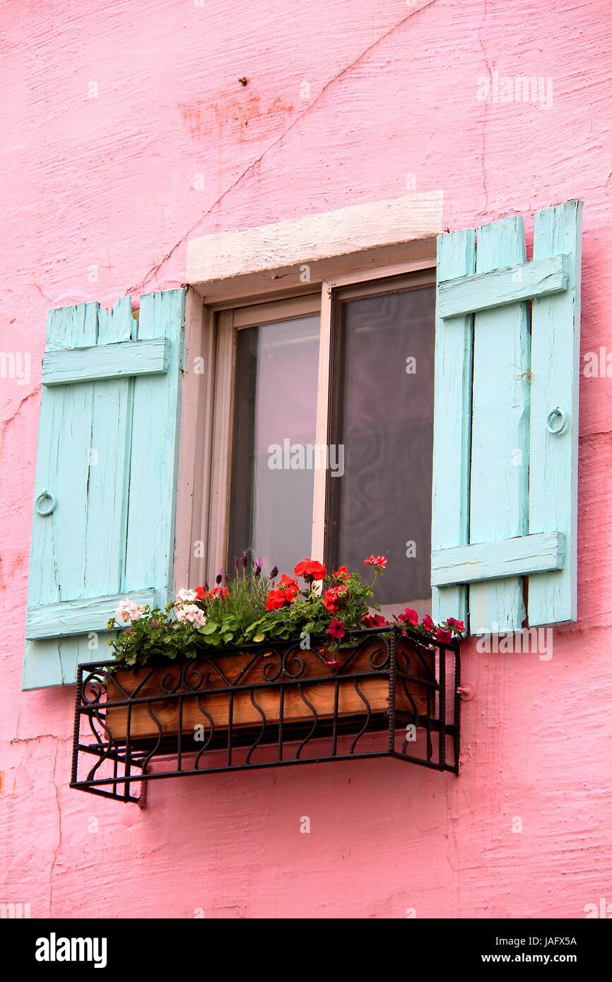 Pink wall of a house with blue window in La Provence Village. Colorful ...