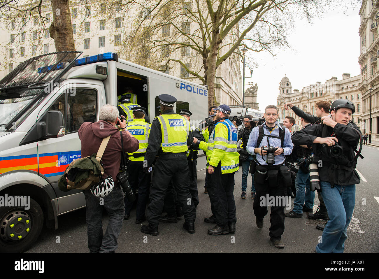 Police officers struggle with a protester at the EDL / Britain First ...