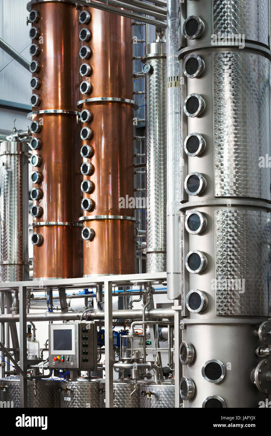 Tall copper distillery chambers in a brewery, brewing storage tanks in ...