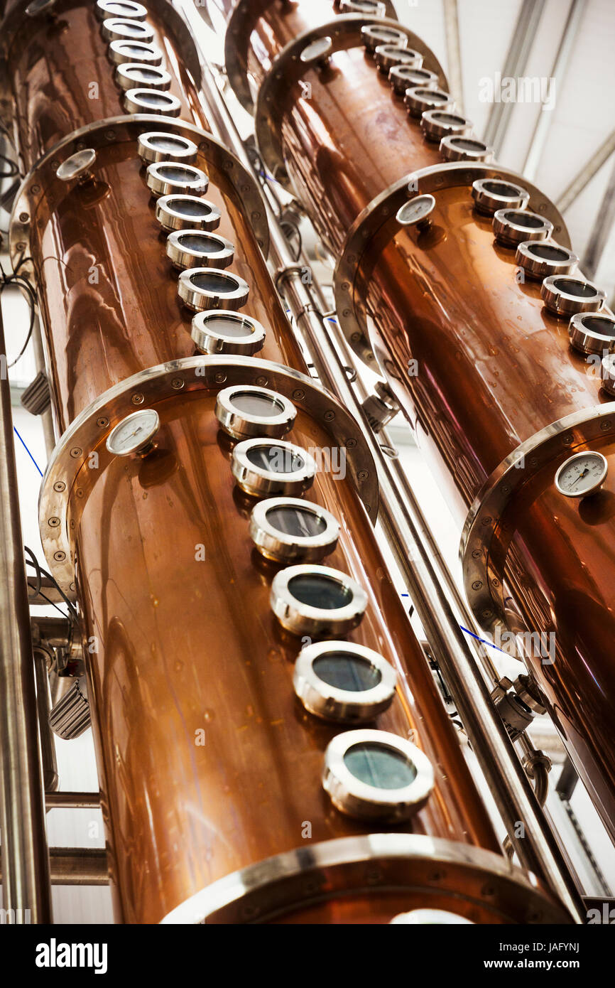 Tall copper distillery chambers in a brewery, brewing storage tanks in ...